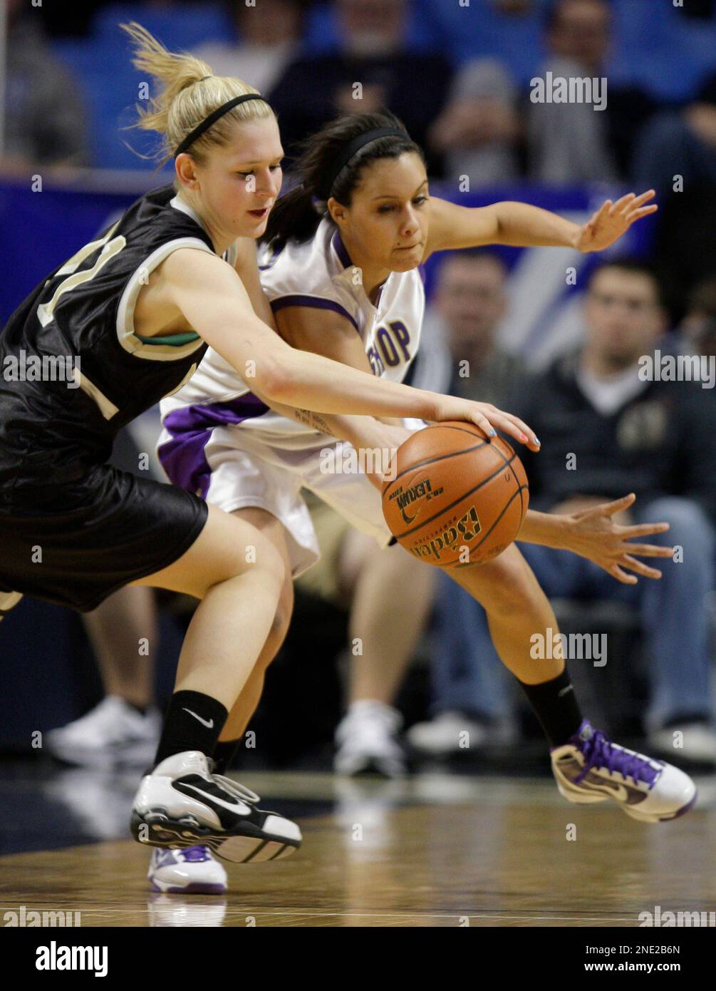 Bishop Guilfoyle High School's Kaleigh Floyd, right, knocks the ball ...