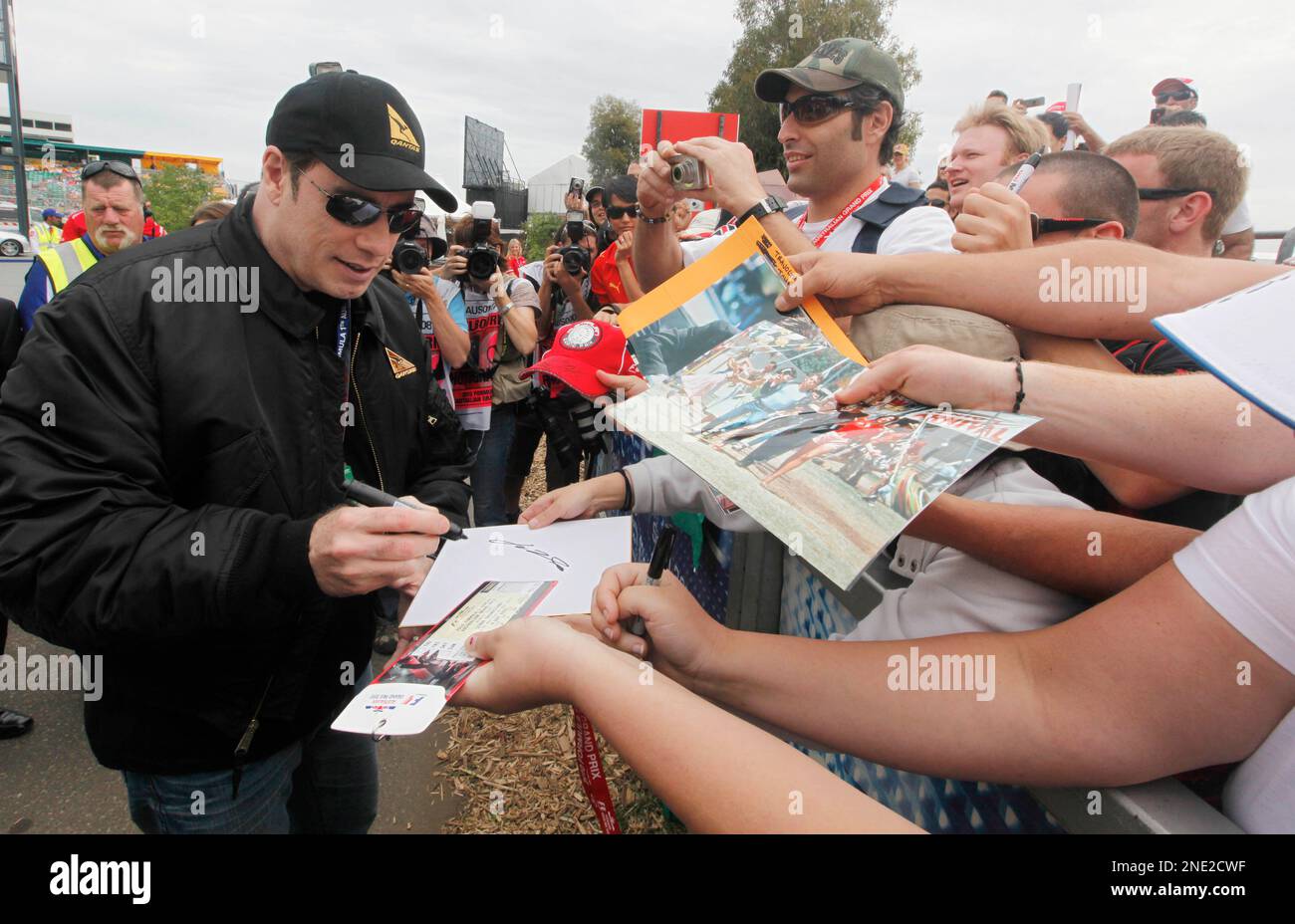 Hollywood movie star John Travolta of the United States signs ...