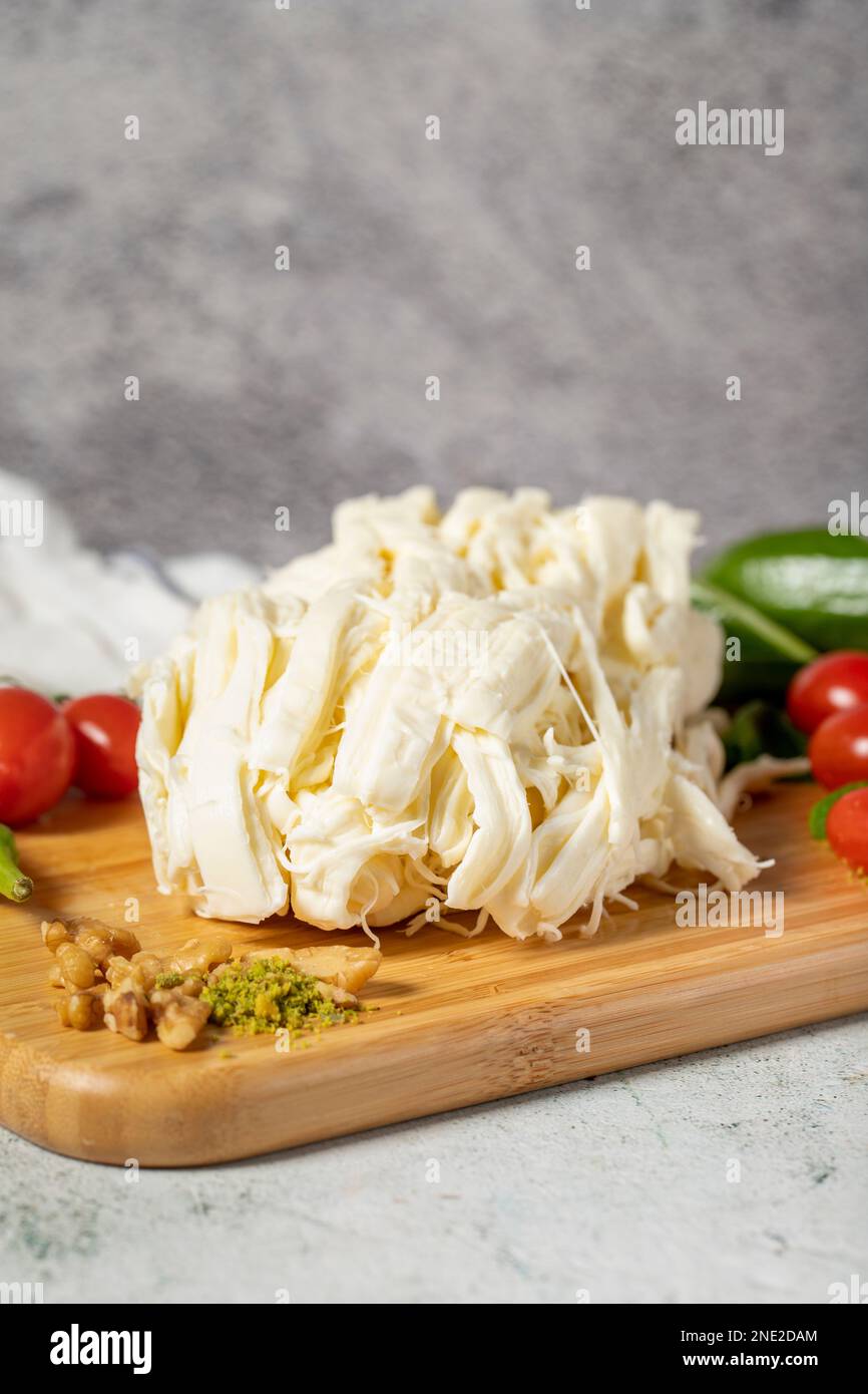 String cheese or Cecil cheese on a wood serving board. Dairy products ...