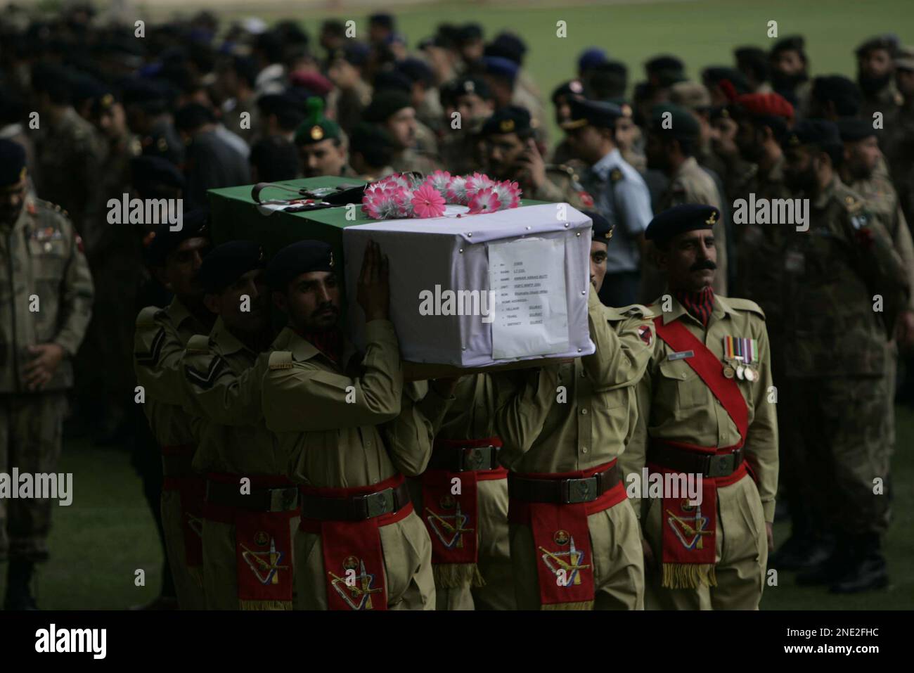 Pakistan army officers carry a coffin of their colleague, who lost his ...