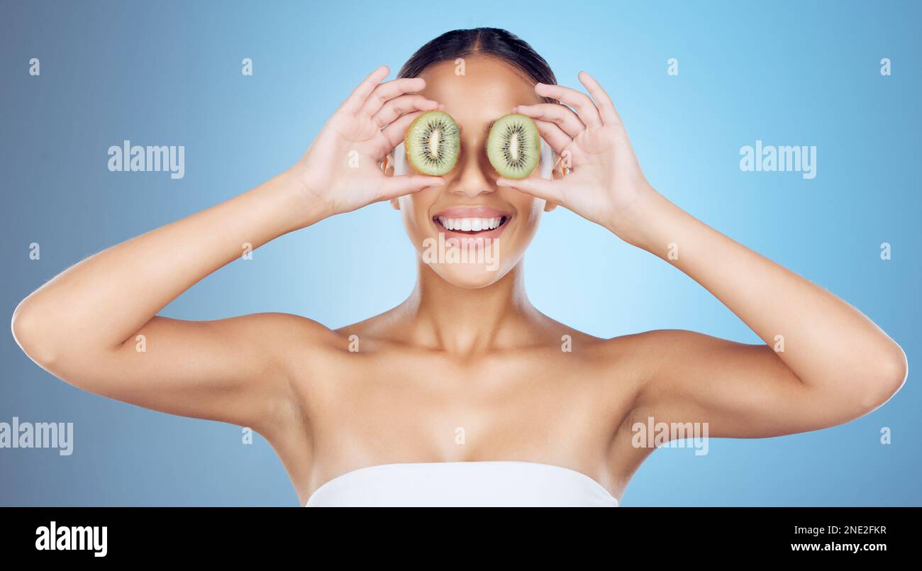 Kiwi, woman and cover face for skincare, beauty and wellness food on ...