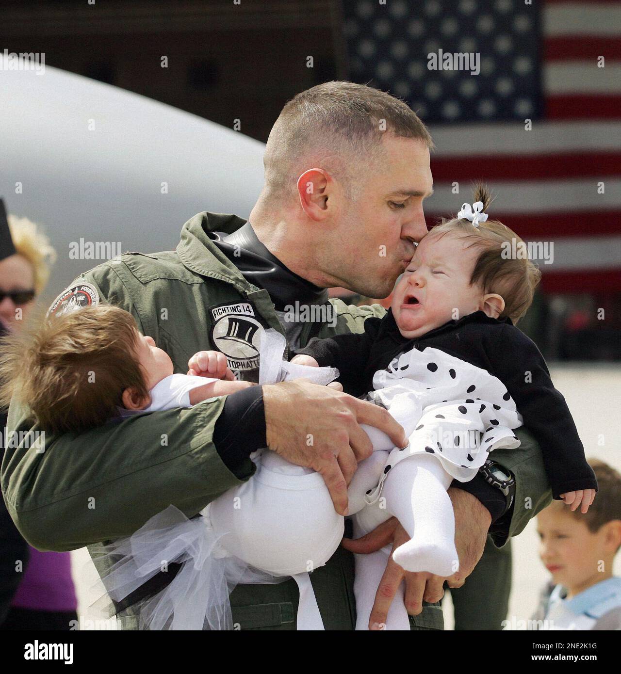 Thomas Locke, a pilot for the VFA-14 Top Hatters, kisses his ...
