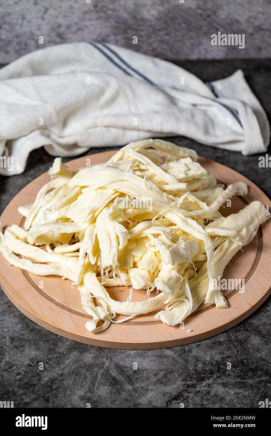 String cheese or Cecil cheese on a wood serving board. Dairy products ...