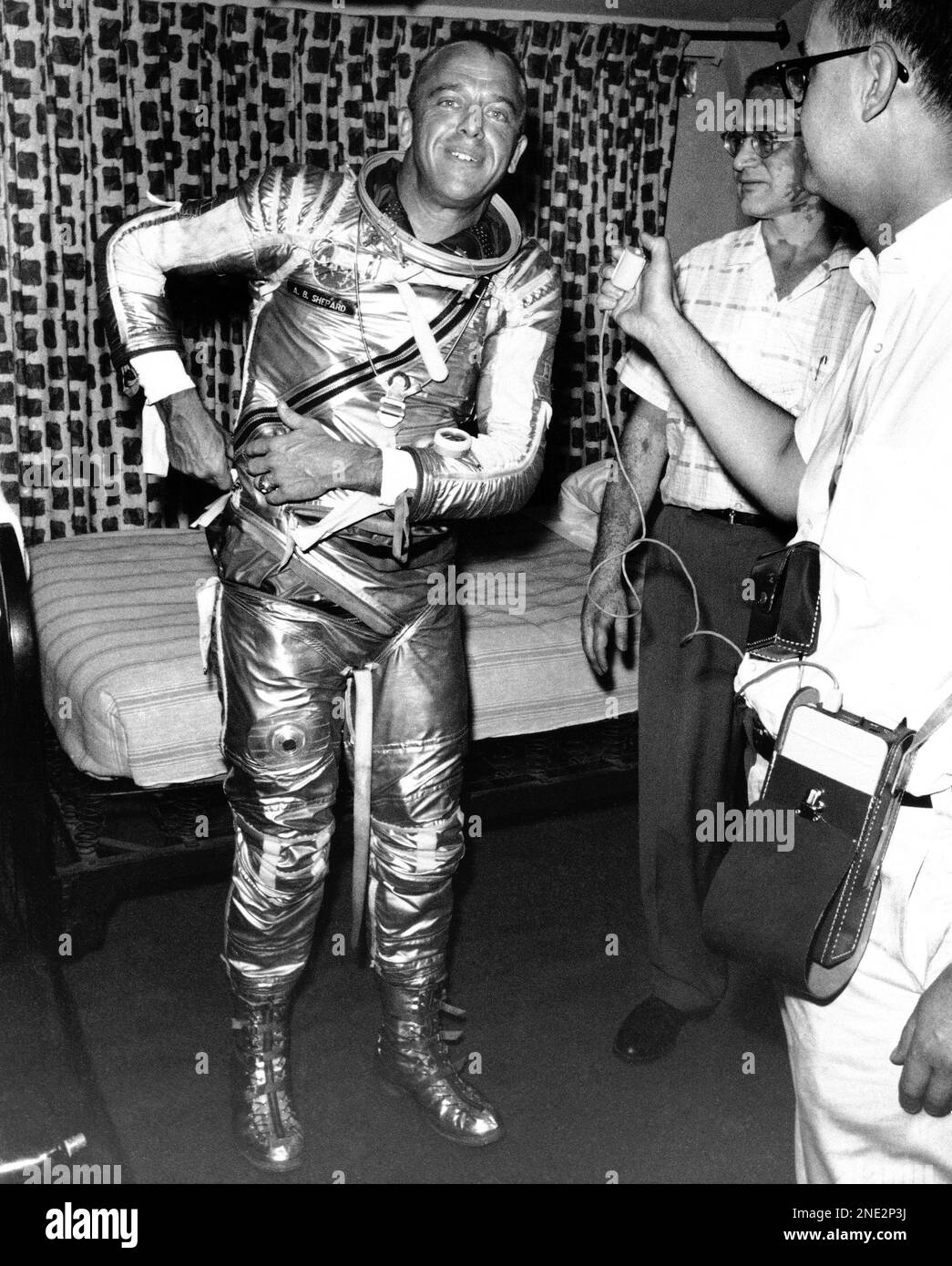 Space man Alan B. Shepard Jr., removes his space suit aboard the ...