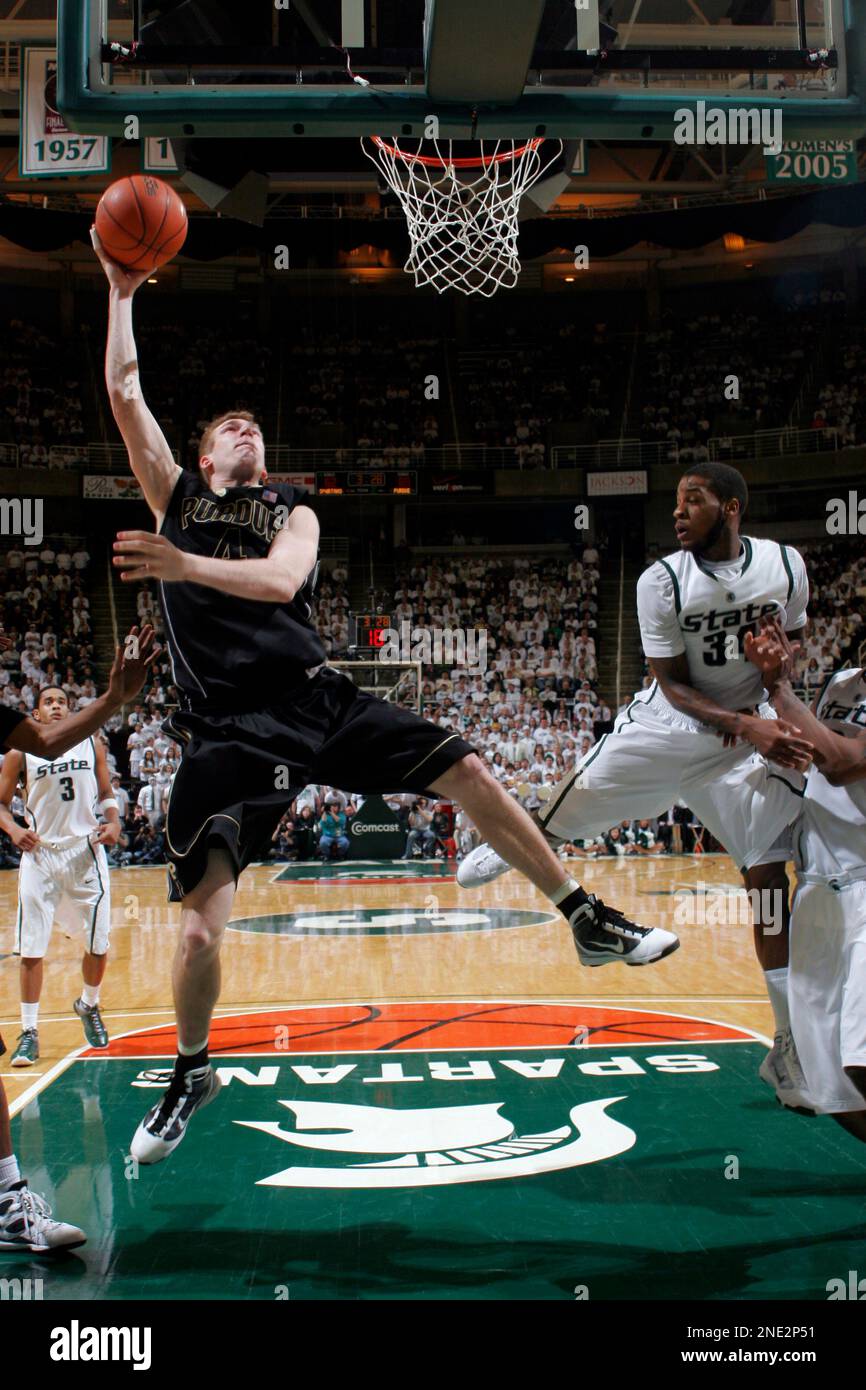 Purdue's Robbie Hummel, left, puts up a shot against Michigan State's ...