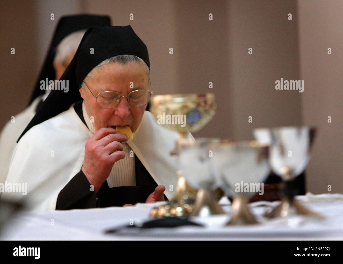 A nun takes a communion host during a mass in a Carmelite convent of ...