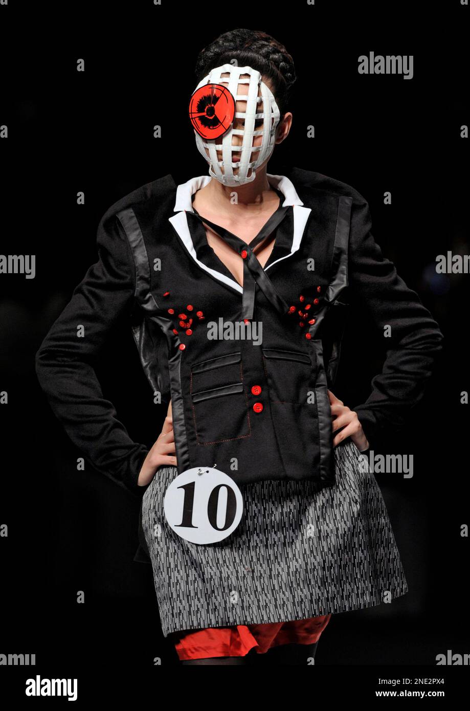 A Chinese model walks on the catwalk stage displaying a creation by ...