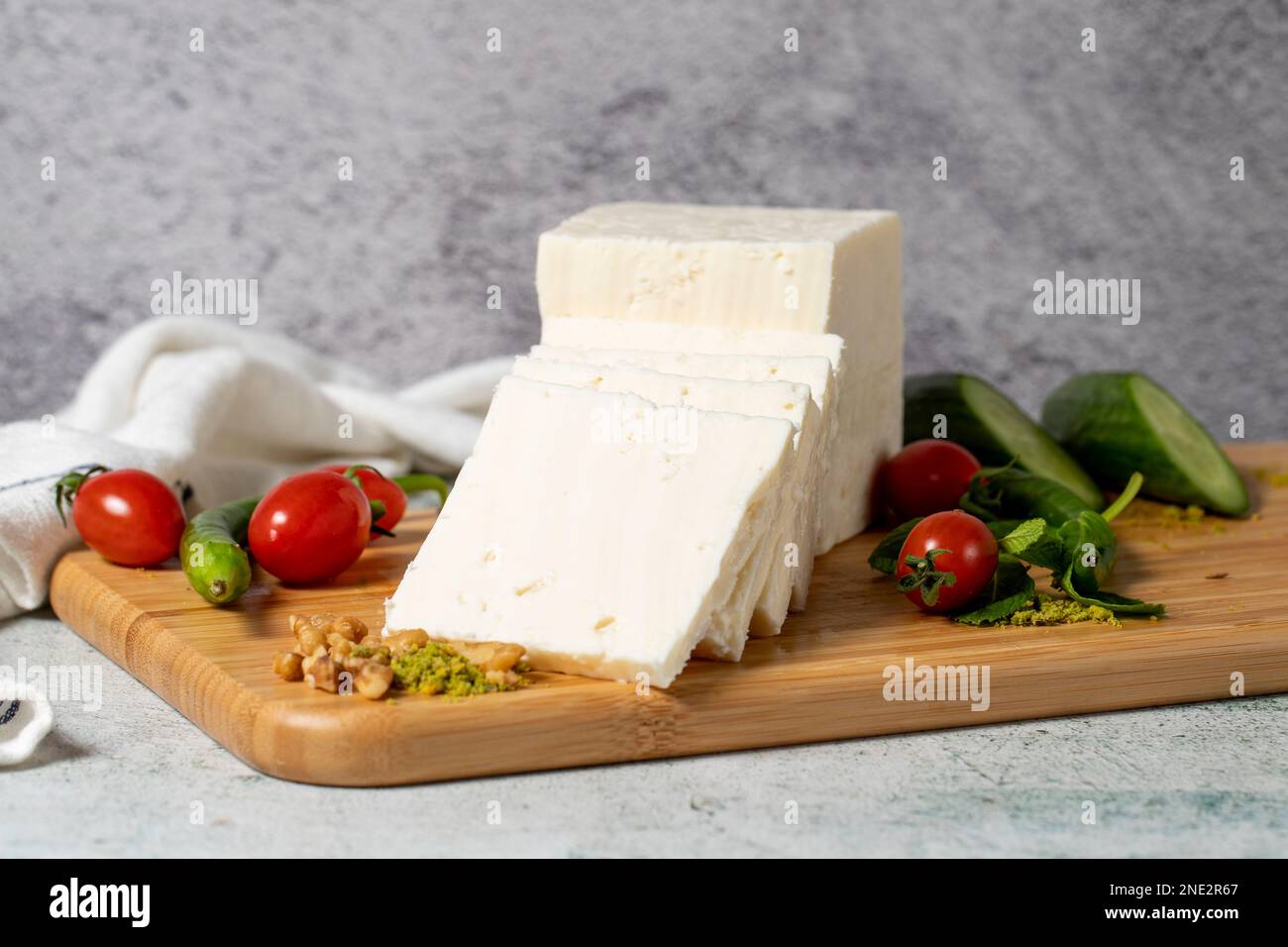 Ripe white cheese. Feta cheese made from cow's milk on a wooden serving ...