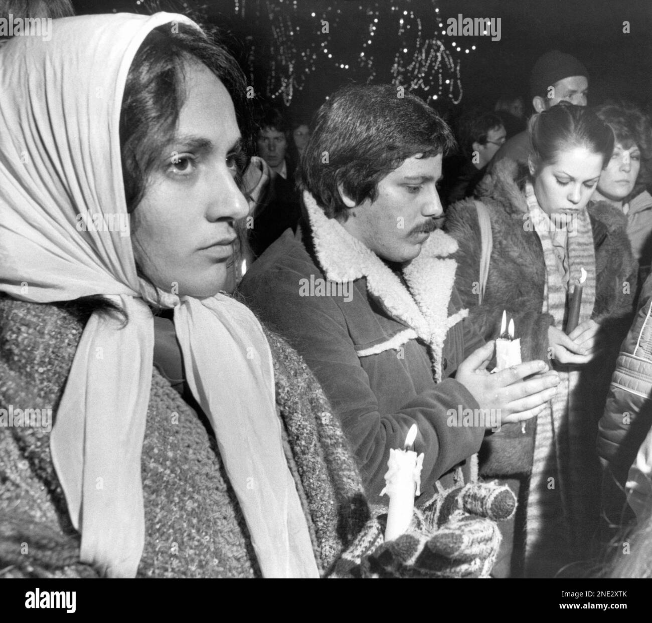 Some of the 400 people bearing candles that gathered for a candlelight ...