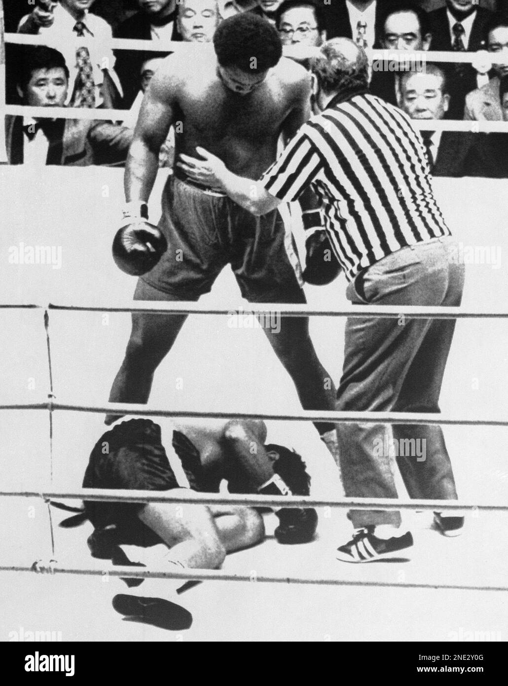 World heavyweight champion George Foreman stands over his opponent Joe ...