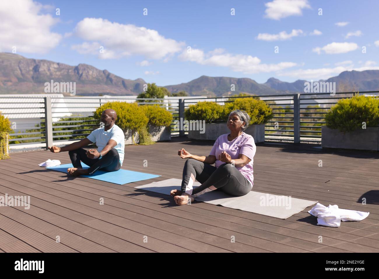 African american senior couple practicing yoga and meditating together ...