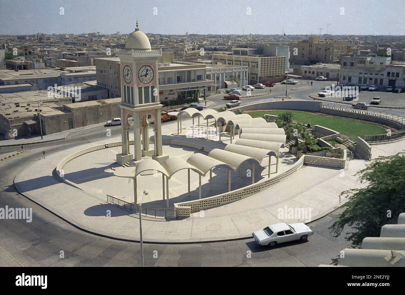 A modern clock tower dominates the industrial centre of Doha, Qatar ...