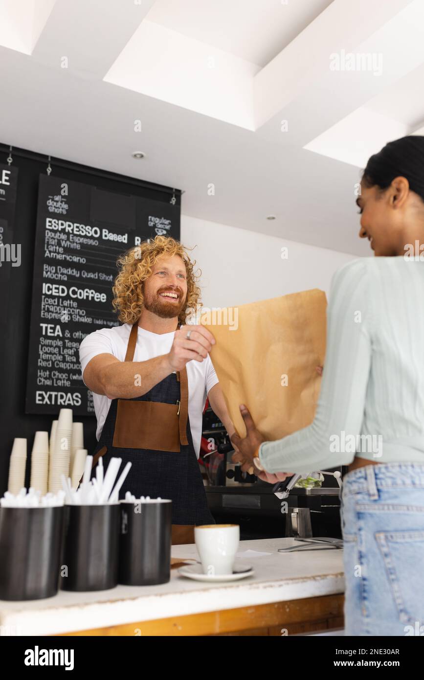 Happy diverse male barista and woman taking order in cafe. Cafe, free ...