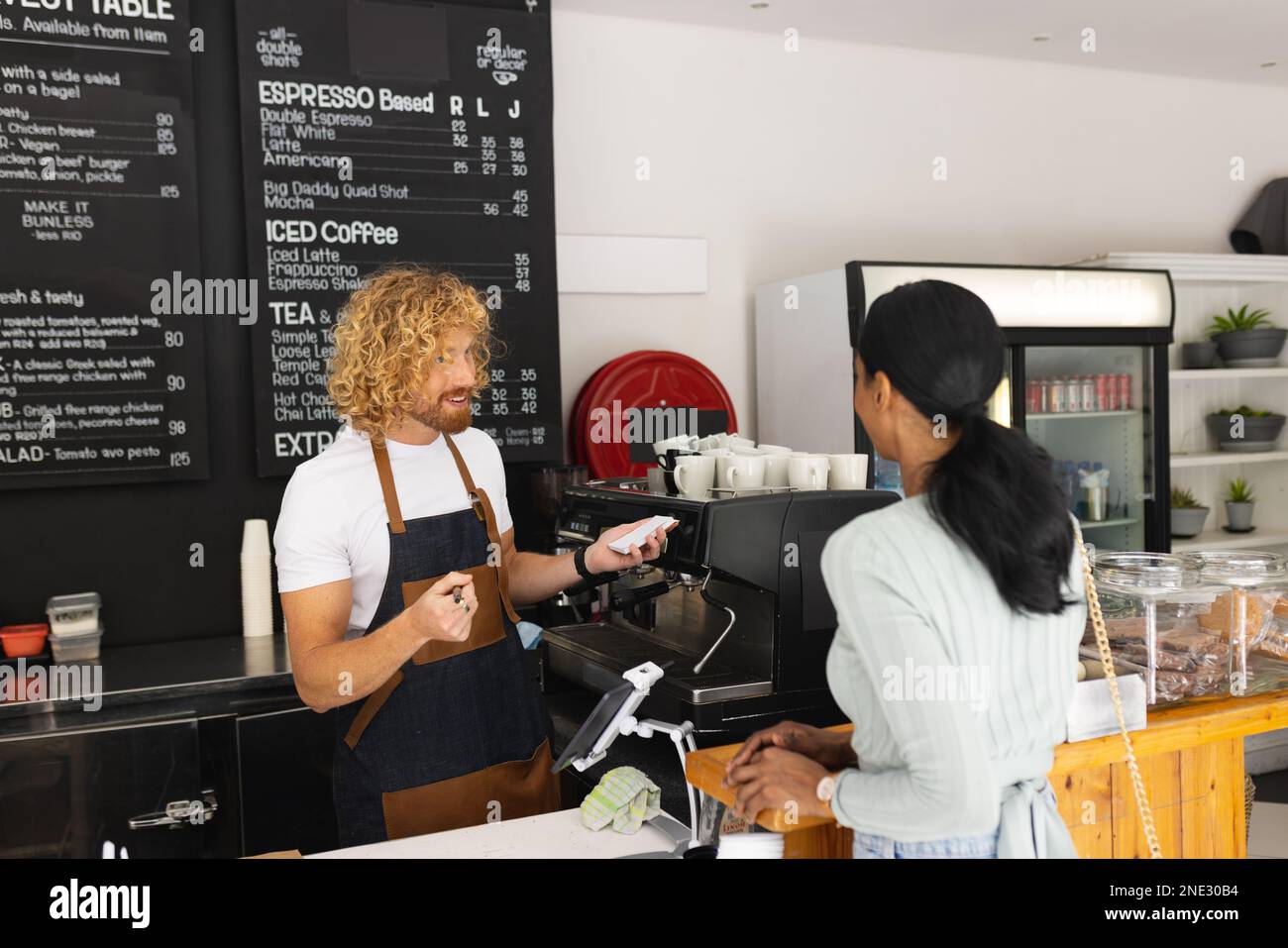 Happy diverse woman and male barista taking order in cafe. Cafe, free ...