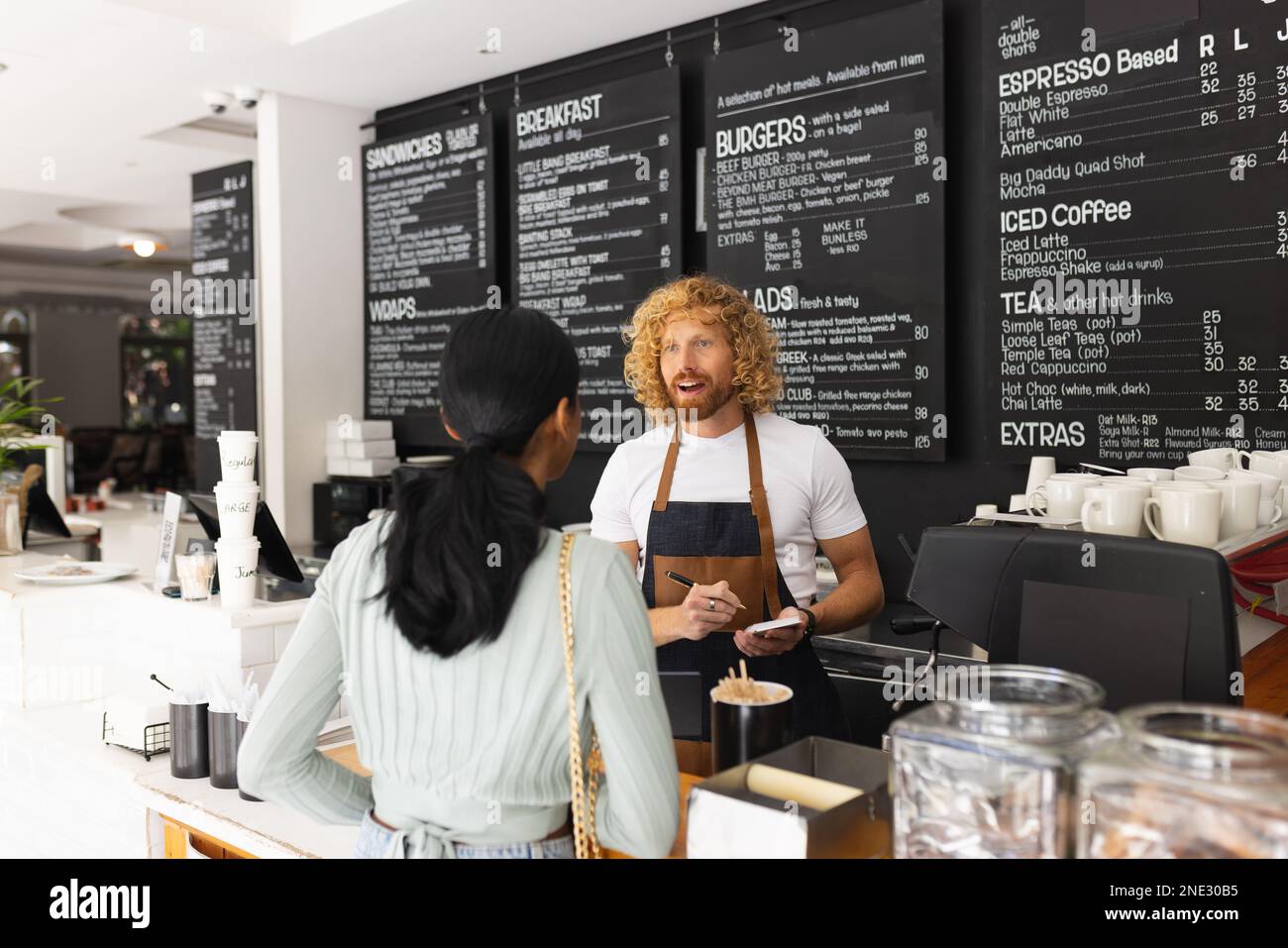 Happy diverse woman and male barista taking order in cafe. Cafe, free ...