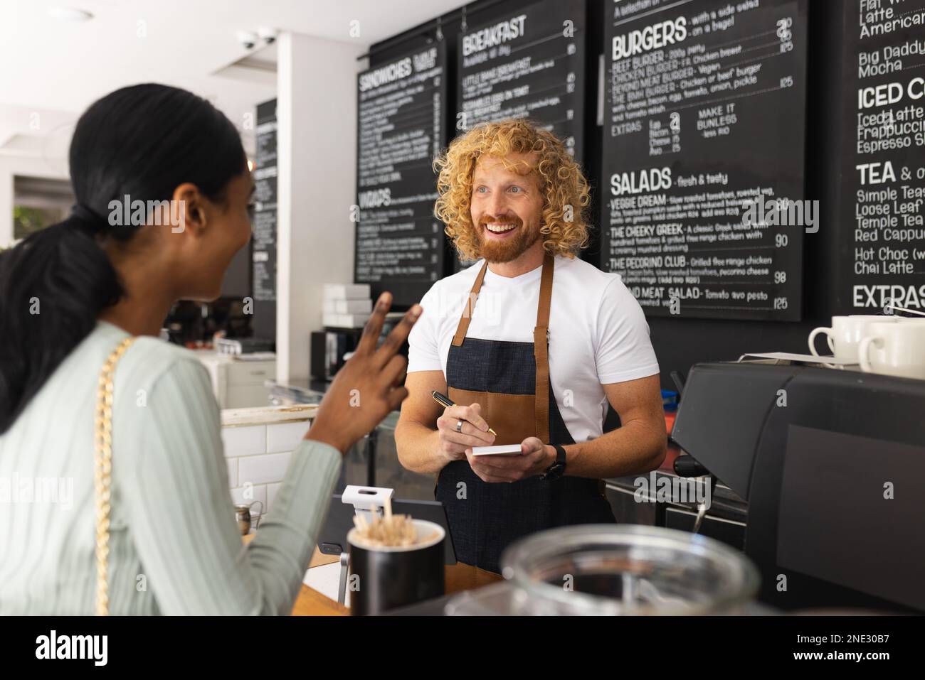Happy diverse woman and male barista taking order in cafe. Cafe, free ...