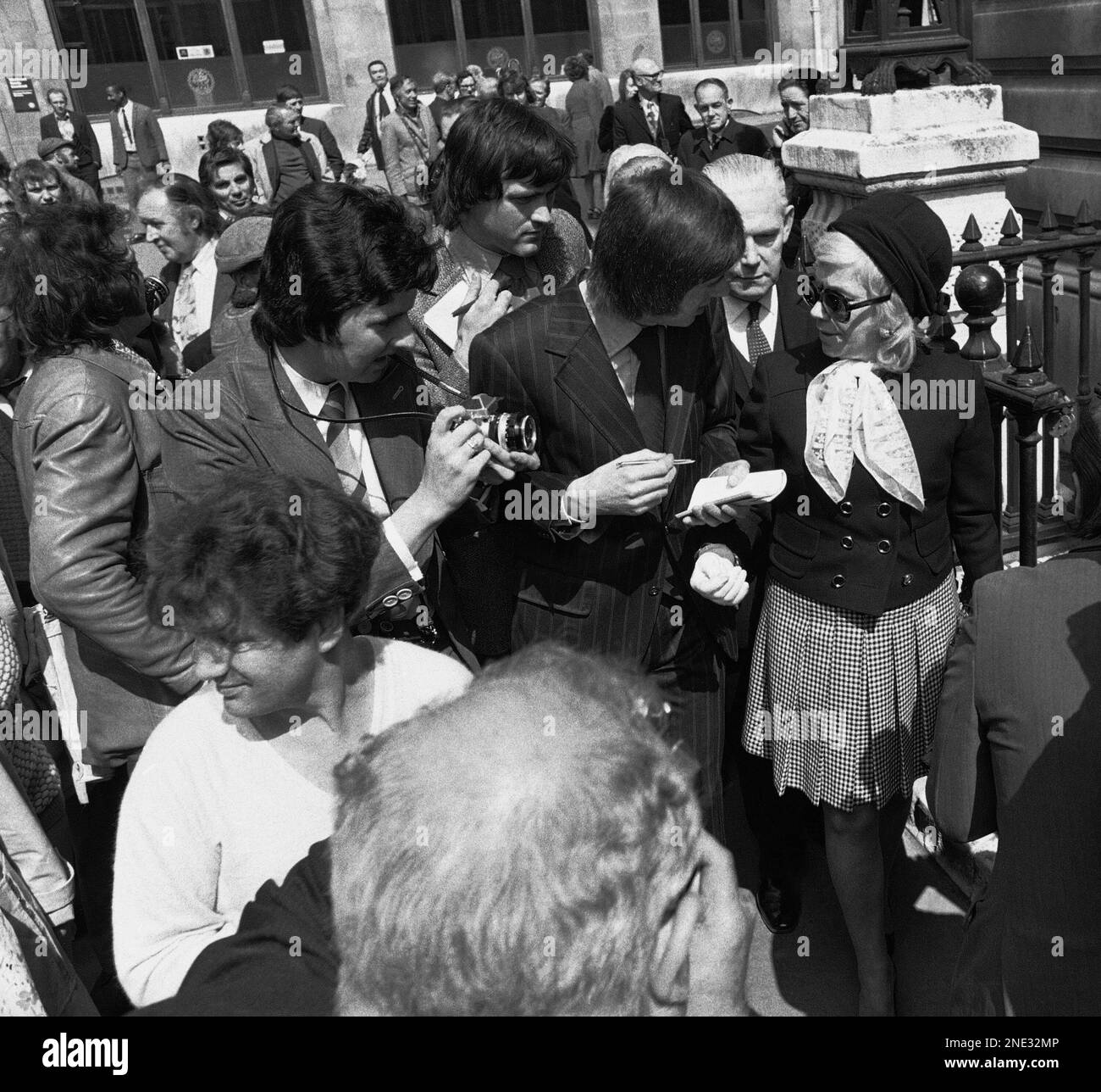 British singer Dorothy Squires is surrounded by newsmen in London ...