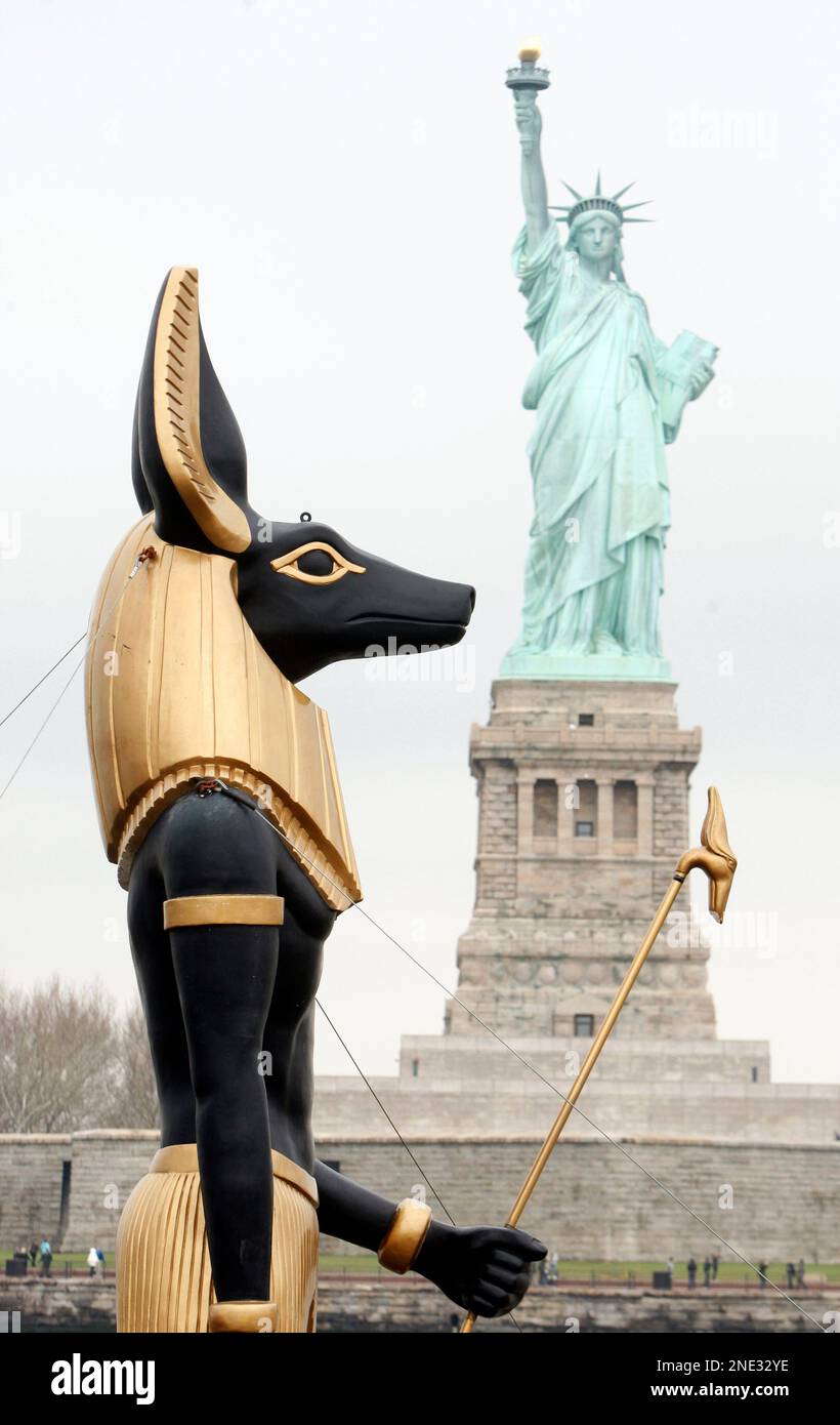 A 25-foot tall replica statue of the Egyptian god Anubis passes in ...