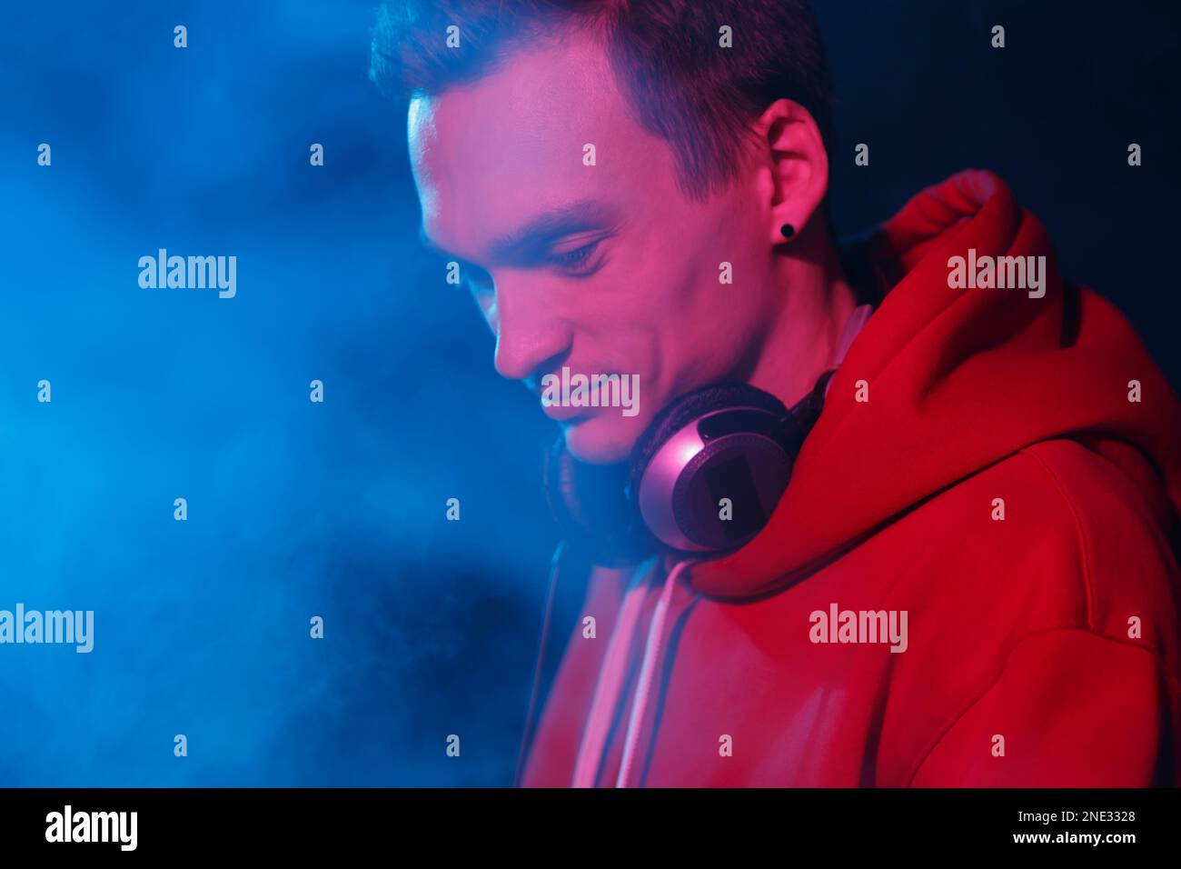 Cool young dj playing music on party in night club. Portrait of ...