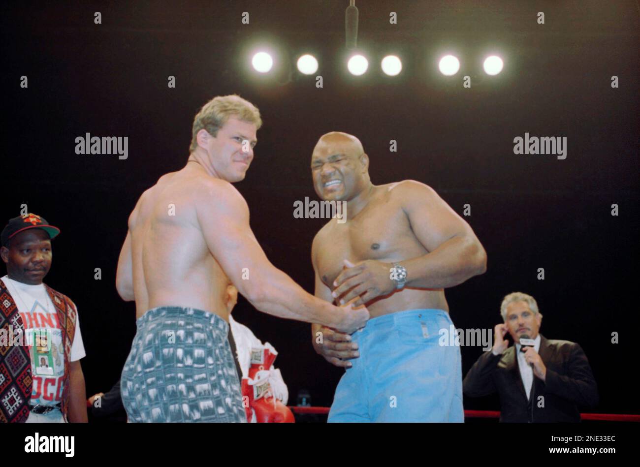 George Foreman, right, grimaces as Tommy Morrison fakes a punch to ...