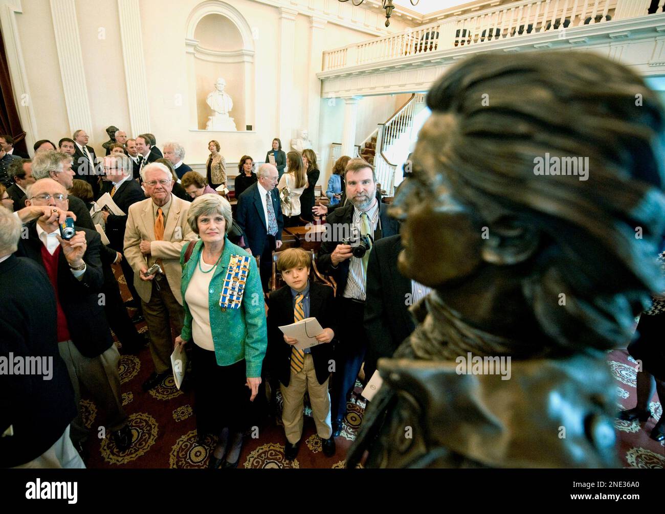 People admire the bust of Andrew Lewis after a dedication ceremony in ...