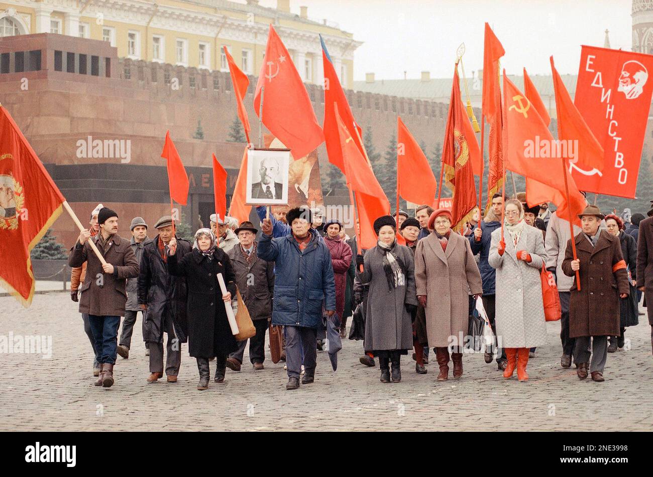 Demonstrators march along Red Square during a pro-Lenin rally in Moscow ...
