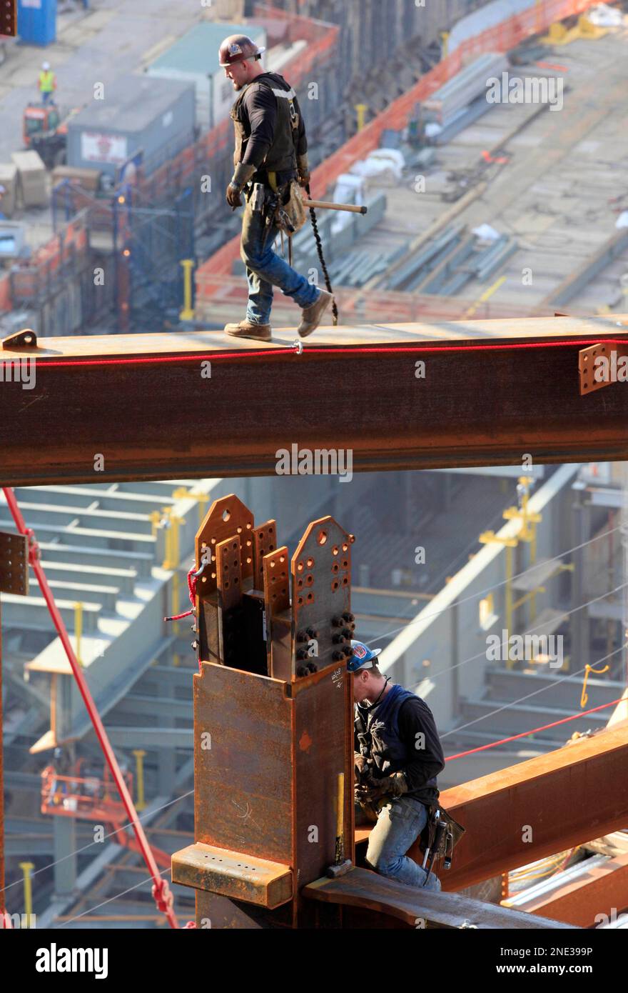 In this March 19, 2010 photo, an ironworkers walks a steel beam at One ...