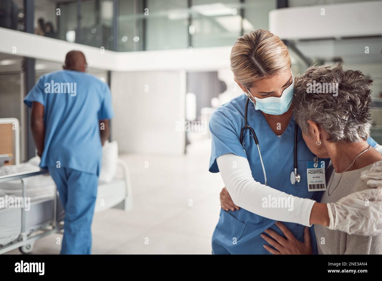 Doctor, hug and sad elderly woman in hospital for support, comfort and ...