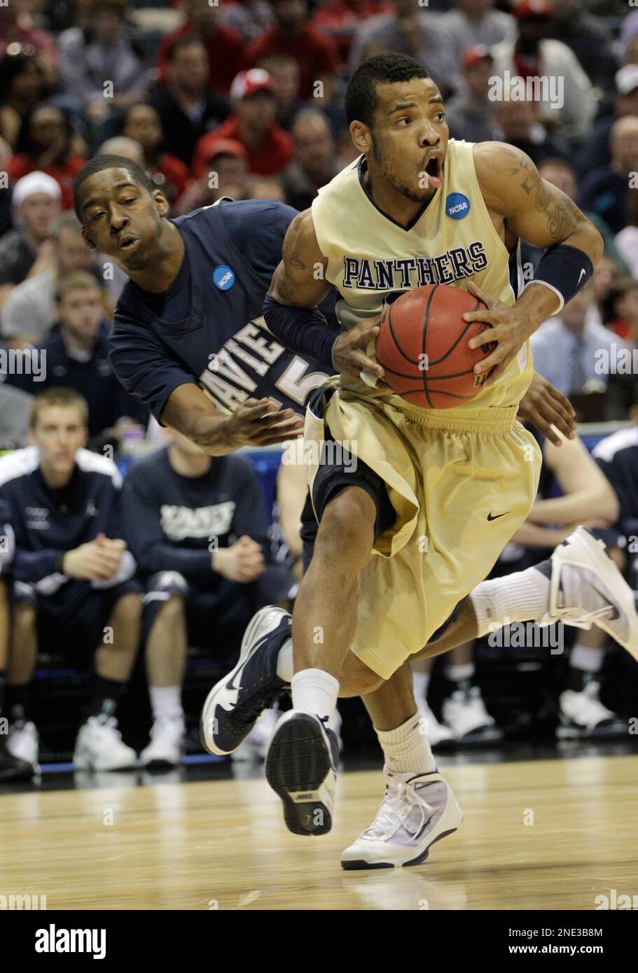 Pittsburgh's Jermaine Dixon drives past Xavier's Dante Jackson in the ...