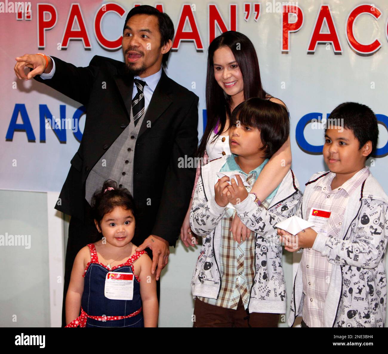 World boxing great Manny Pacquiao gestures as he poses with his family ...