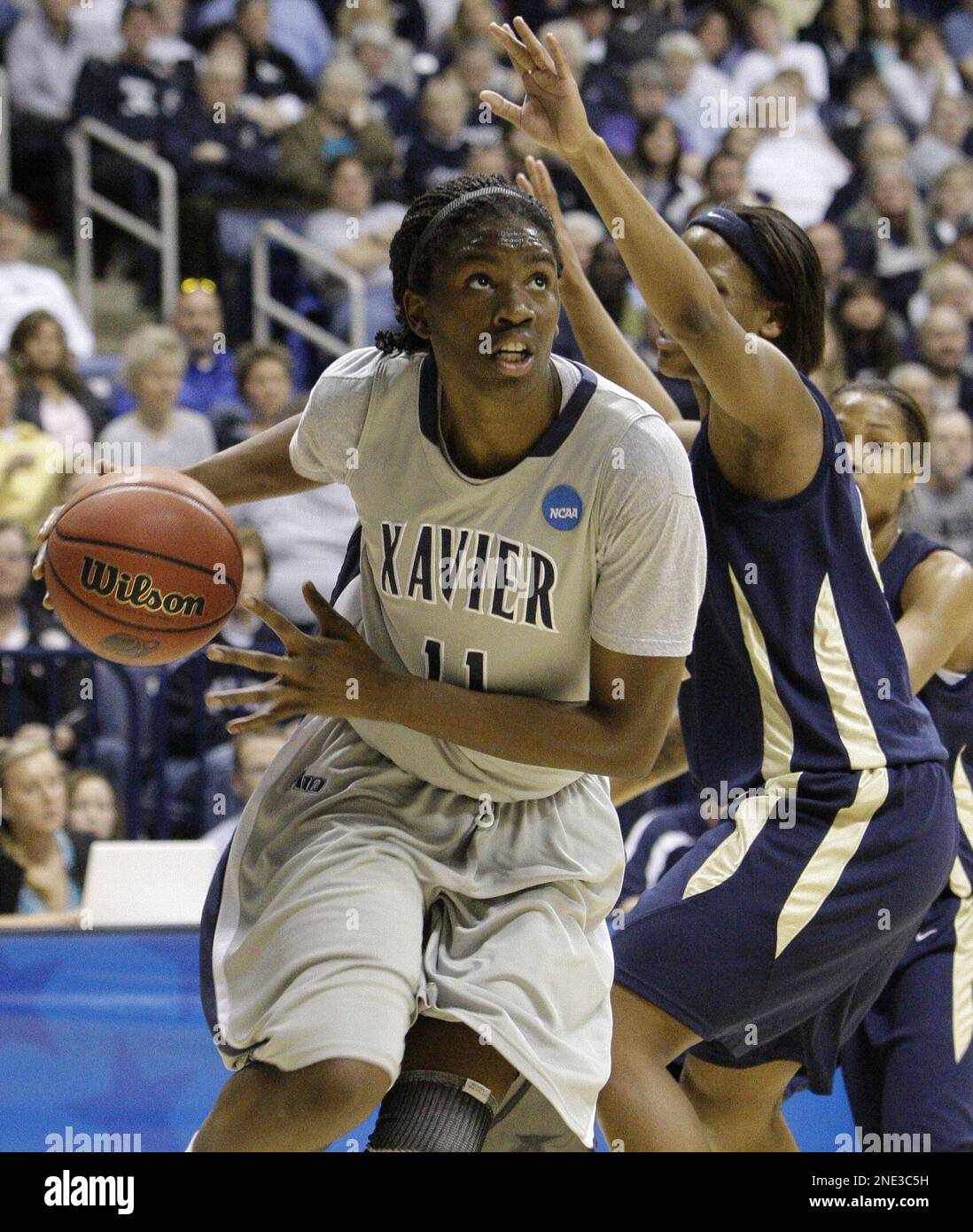 Xavier forward Amber Harris (11) drives past East Tennessee State guard ...