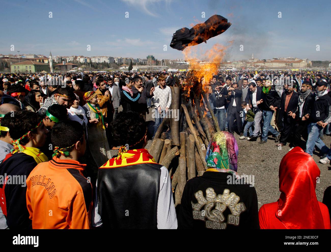 Turkish Kurds dance around a bonfire as they celebrate the Nowruz in ...