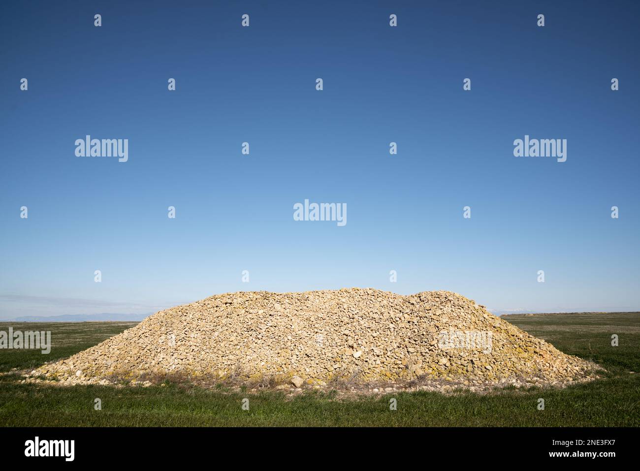 Stones piled up in a crop field and clear sky in Spain Stock Photo - Alamy