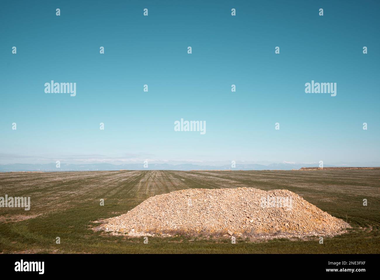 Stones piled up in a crop field and clear sky in Spain Stock Photo - Alamy
