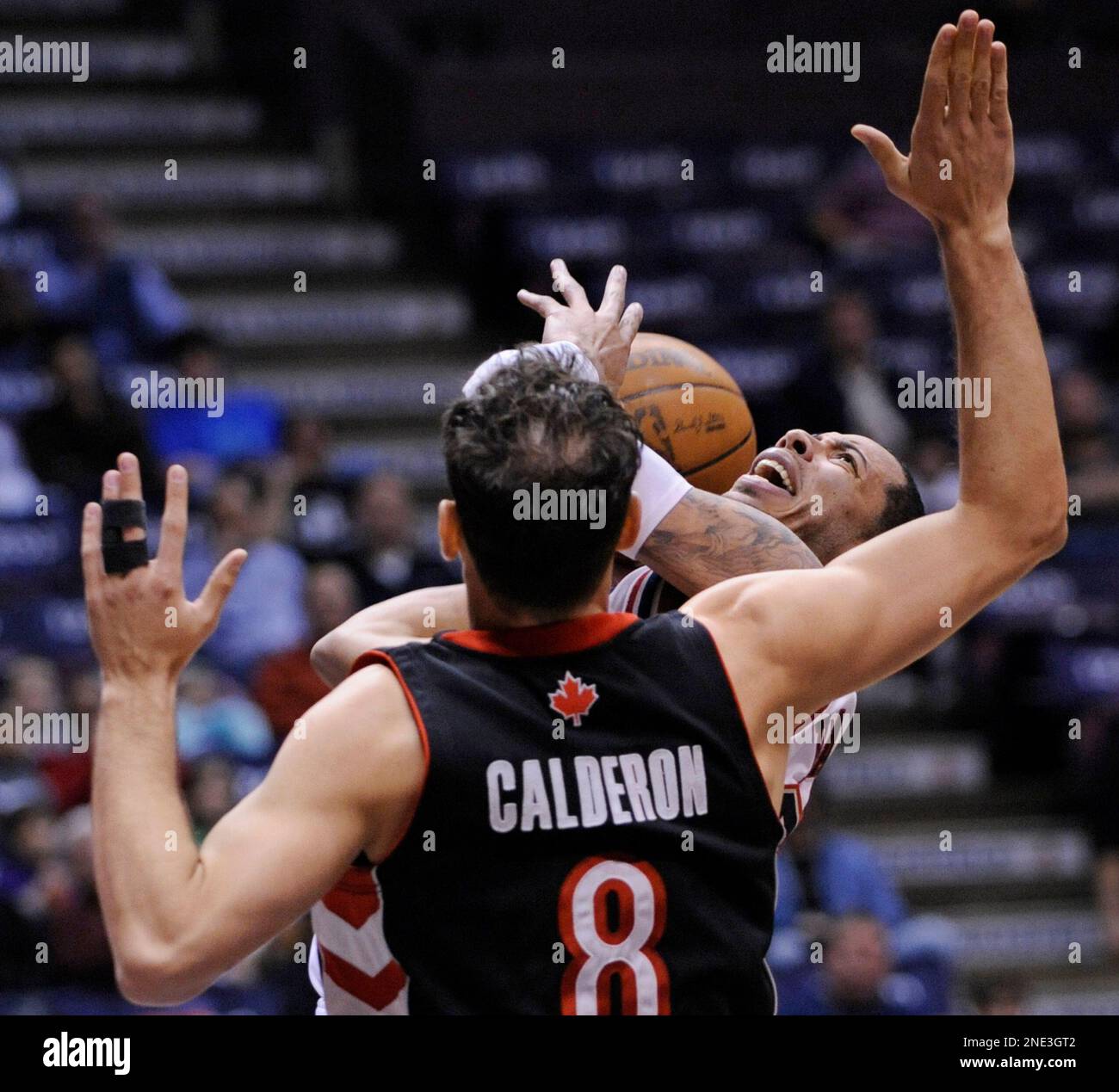 New Jersey Nets' Devin Harris attempts a shot as he is guarded by ...