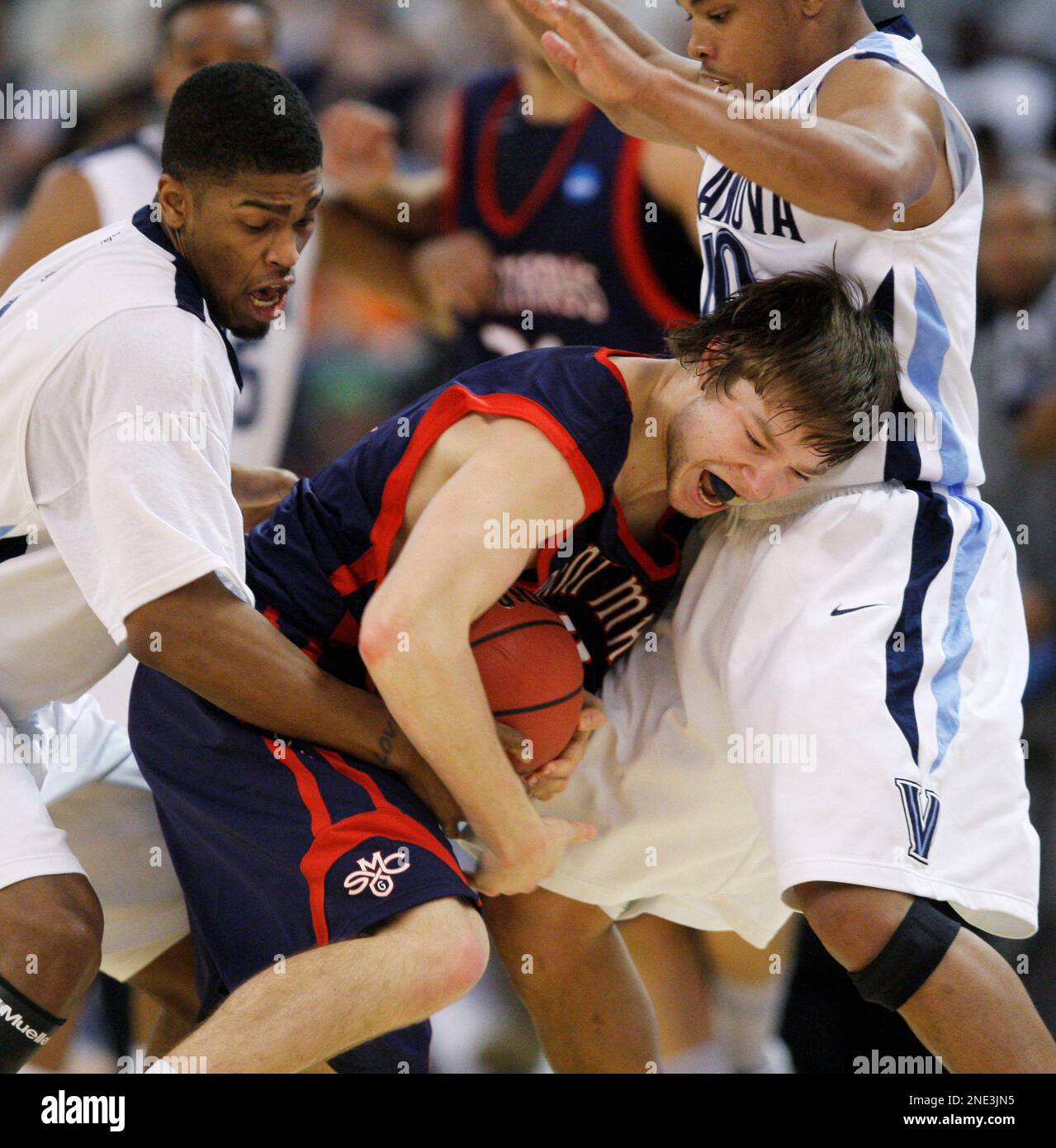 Villanova's Antonio Pena, left, and Corey Fisher, right, tie up Saint ...
