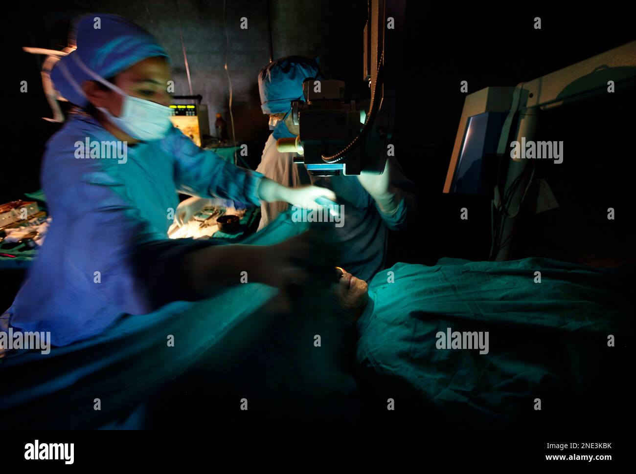 In this Feb. 13, 2010 photograph, a surgical assistant covers the face ...