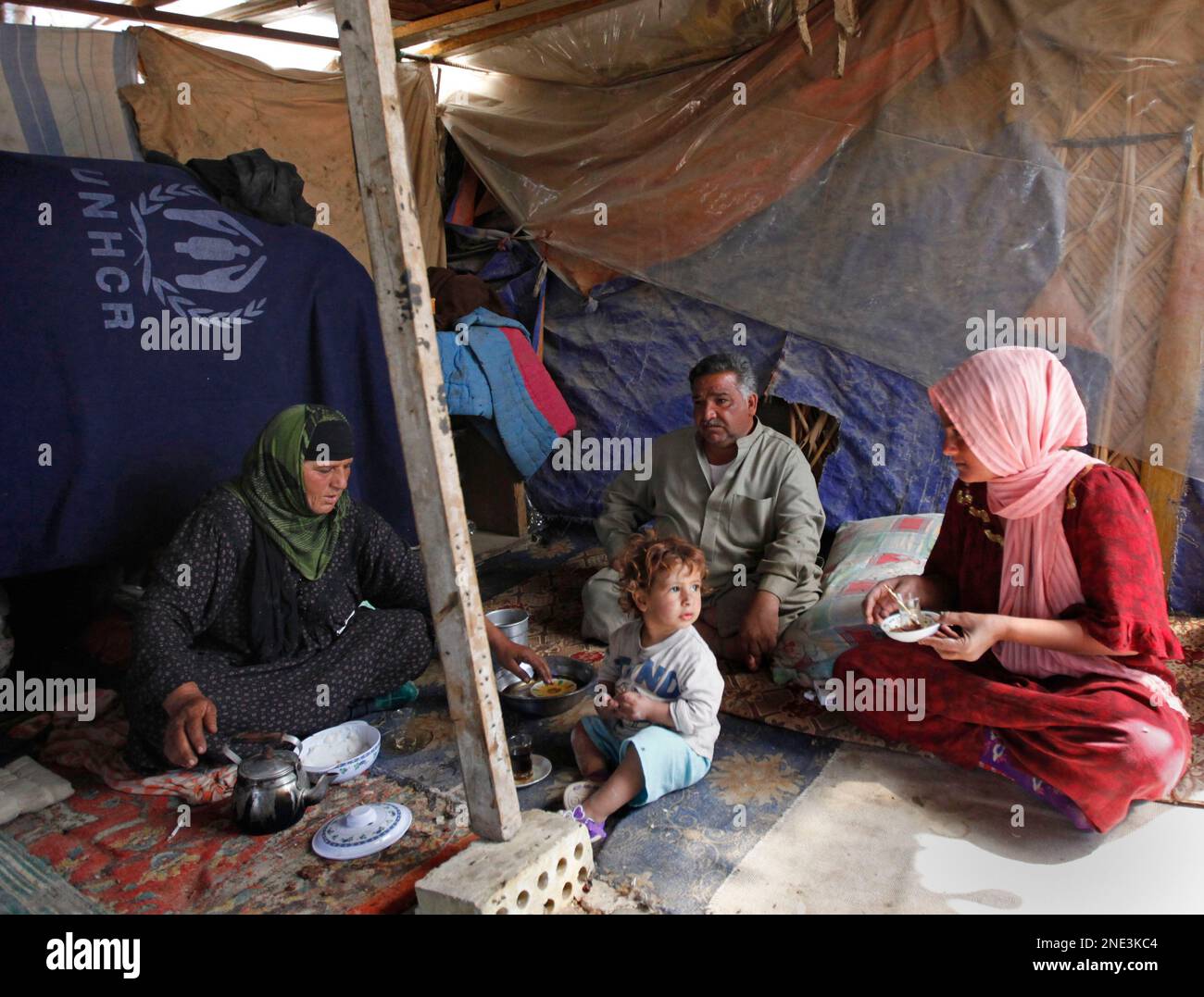 An Iraqi family gathers for lunch at a military base belonging to the ...