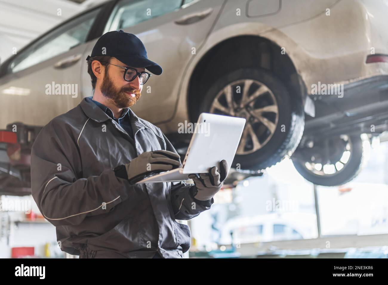 Repair shop worker doing car's system inspection on a computer. Repair ...