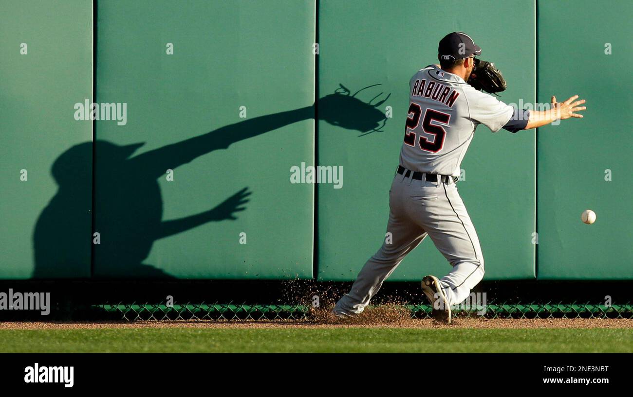 Detroit Tigers center fielder Ryan Raburn goes to the wall but misses a ...