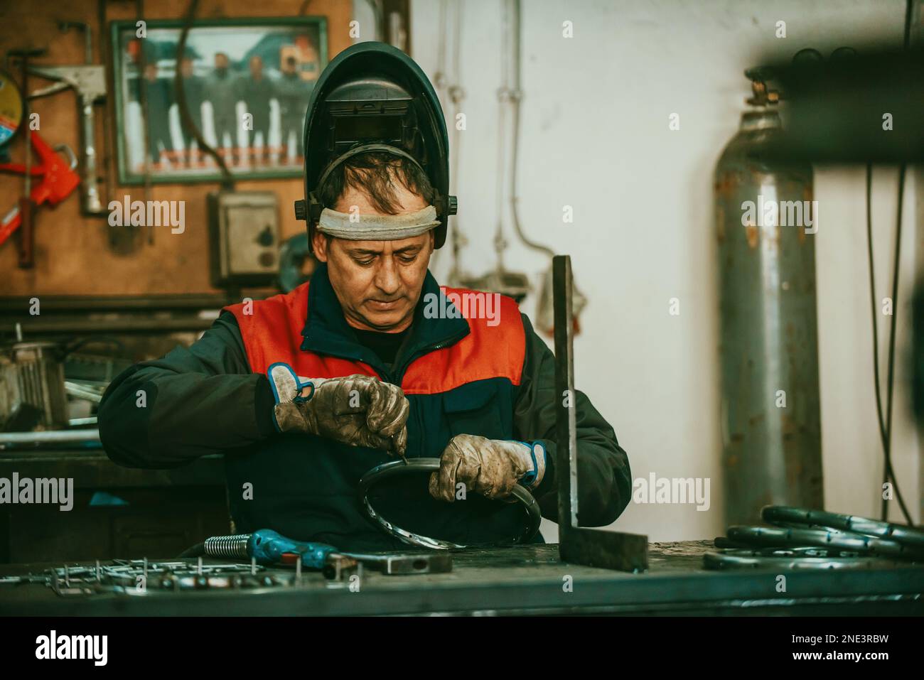 A worker in an industry preparing iron structures for welding Stock ...