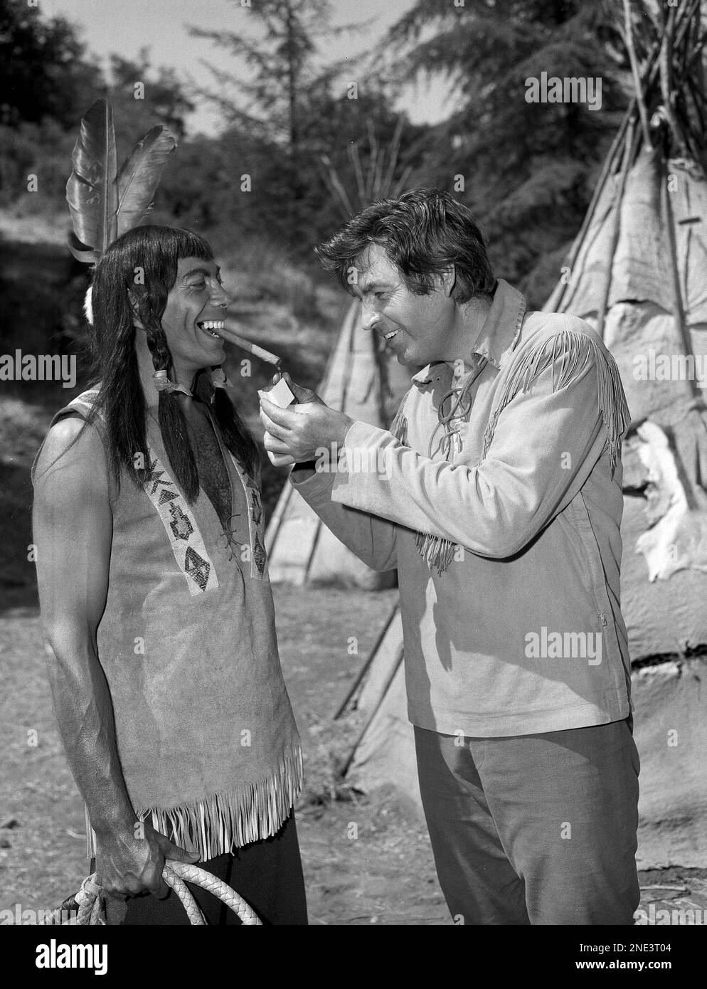 Fess Parker, star of the NBC-TV "Daniel Boone" show, lights the cigar ...