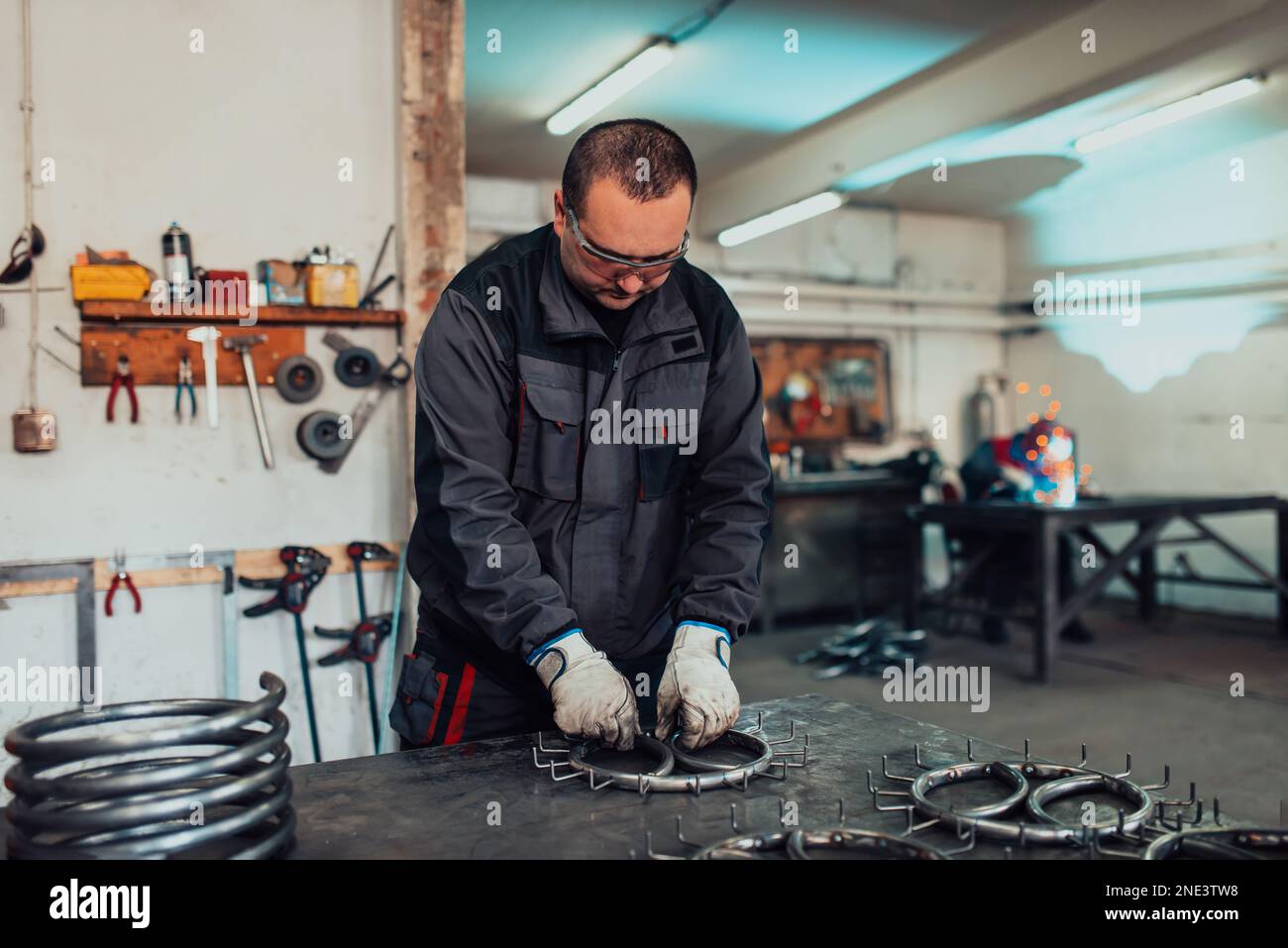 An industrial worker processing iron structures and preparing them for processing Stock Photo ...