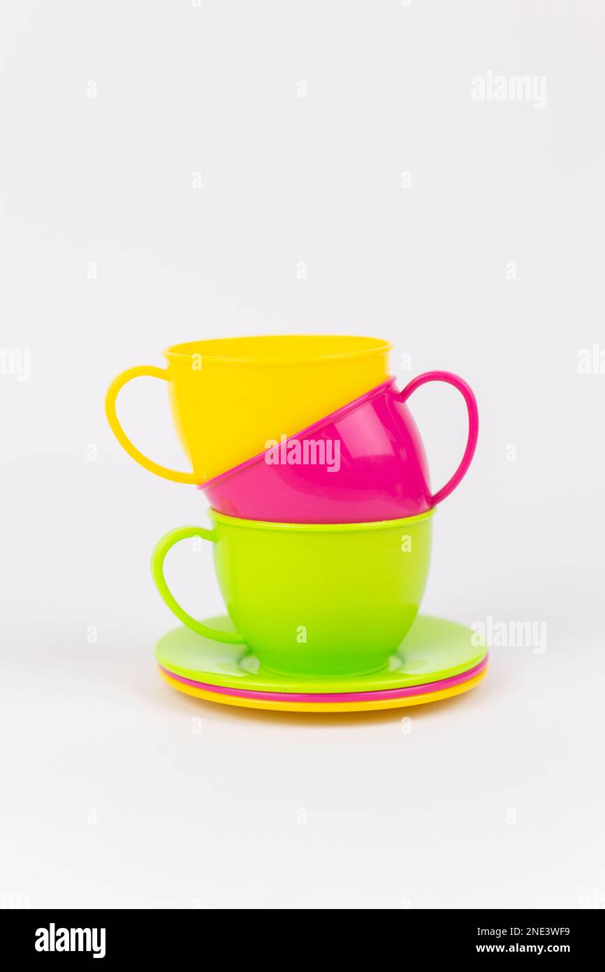 a multi-colored plastic cups and plates on a white background kitchen ...