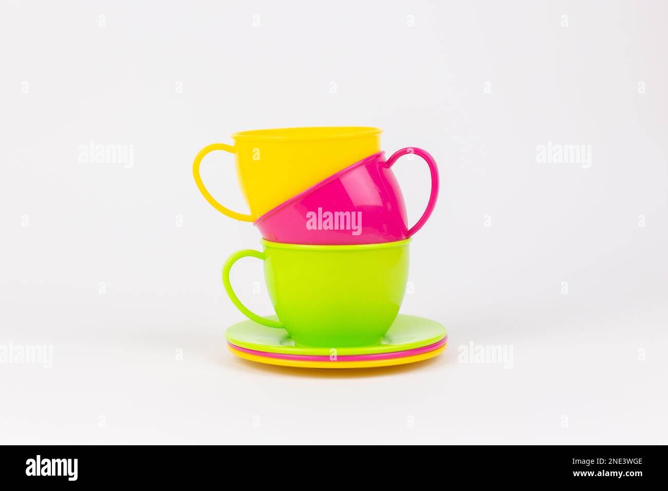 a multi-colored plastic cups and plates on a white background kitchen ...