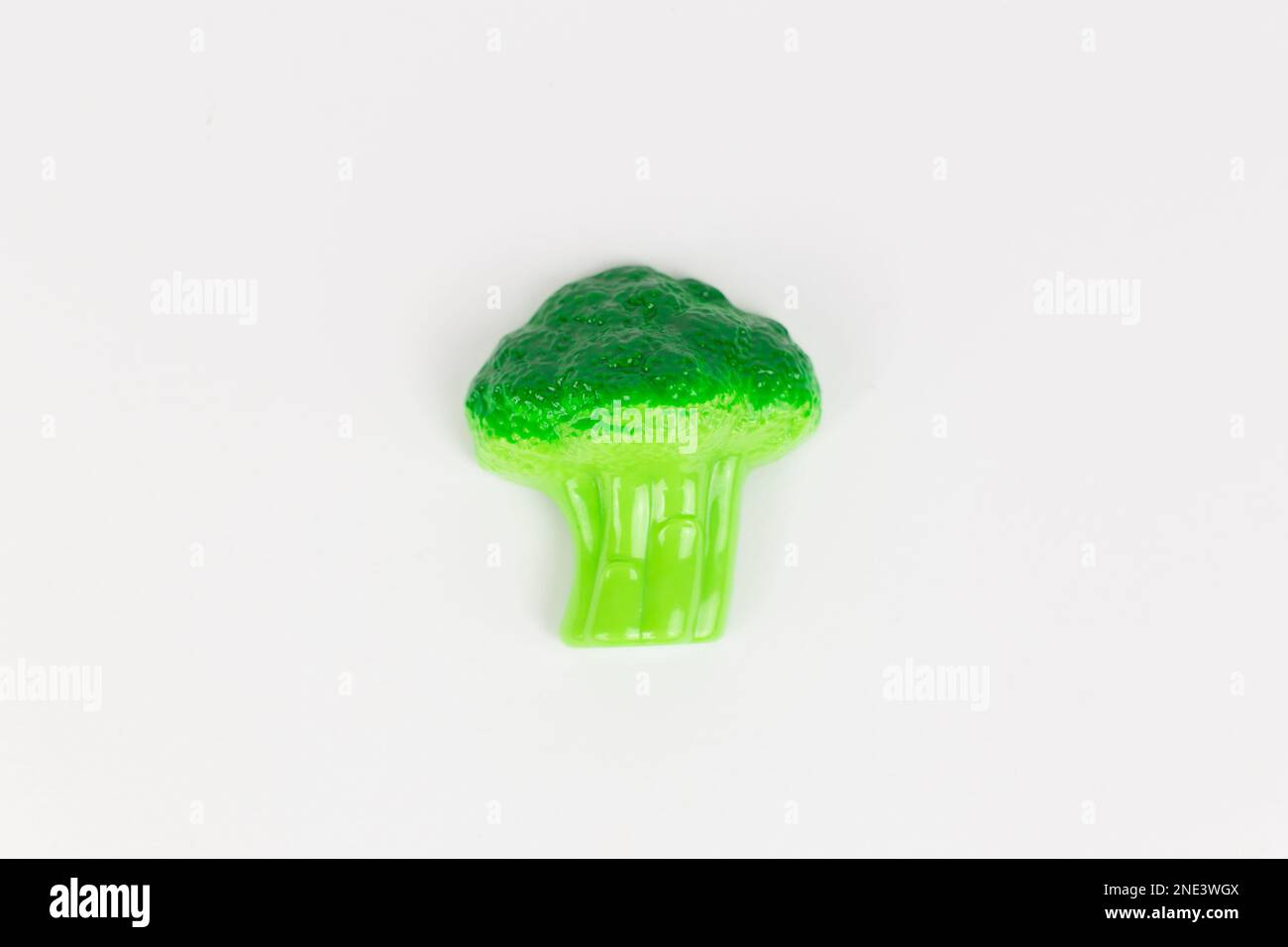 a plastic toy broccoli on a white background vegetable Stock Photo - Alamy
