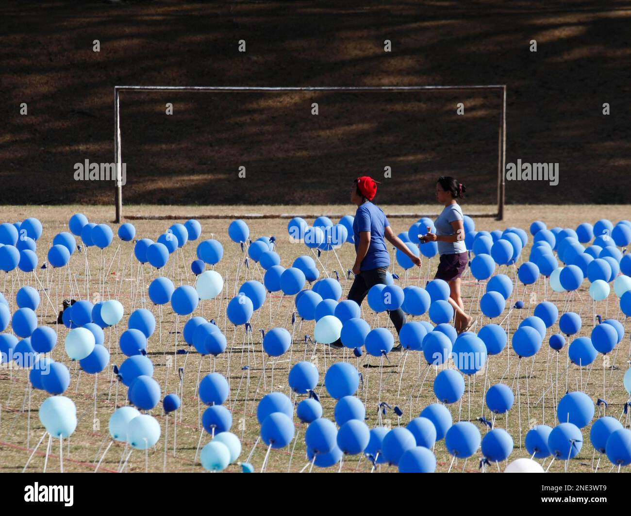 Students from the University of the Philippines walk through an art ...