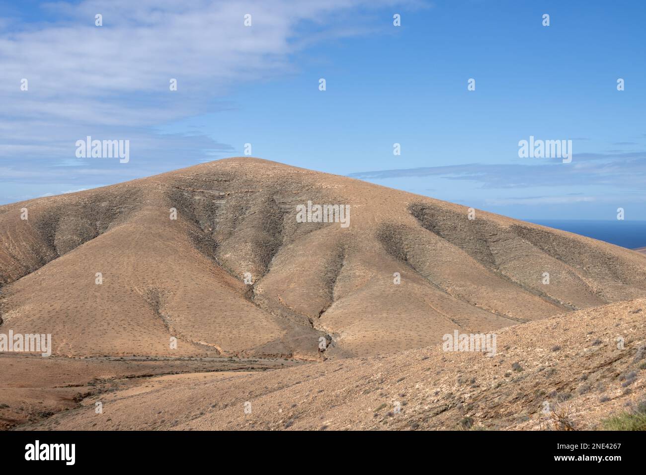 Shapes and lines of the mountains of the volcanic origin. Light brown ...