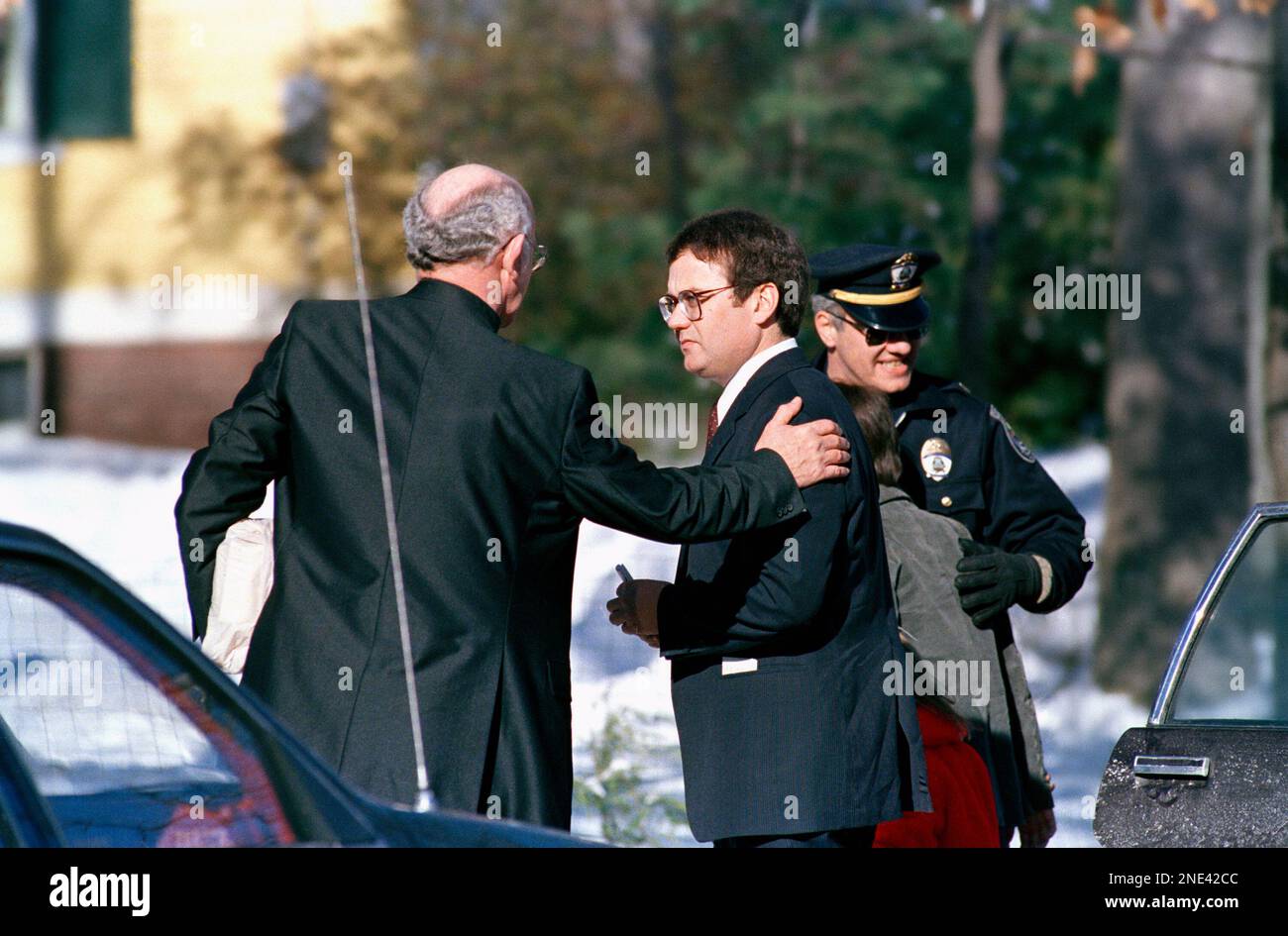 Steven McAuliffe, right, is consoled by an unidentified man outside ...