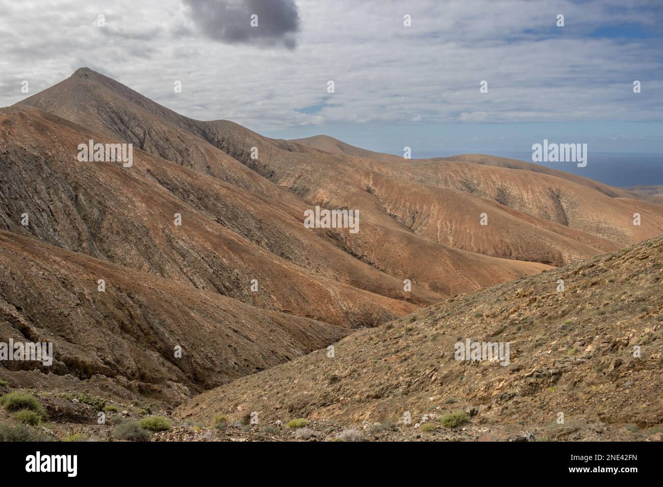 Shapes and lines of the mountains of the volcanic origin. Light brown ...